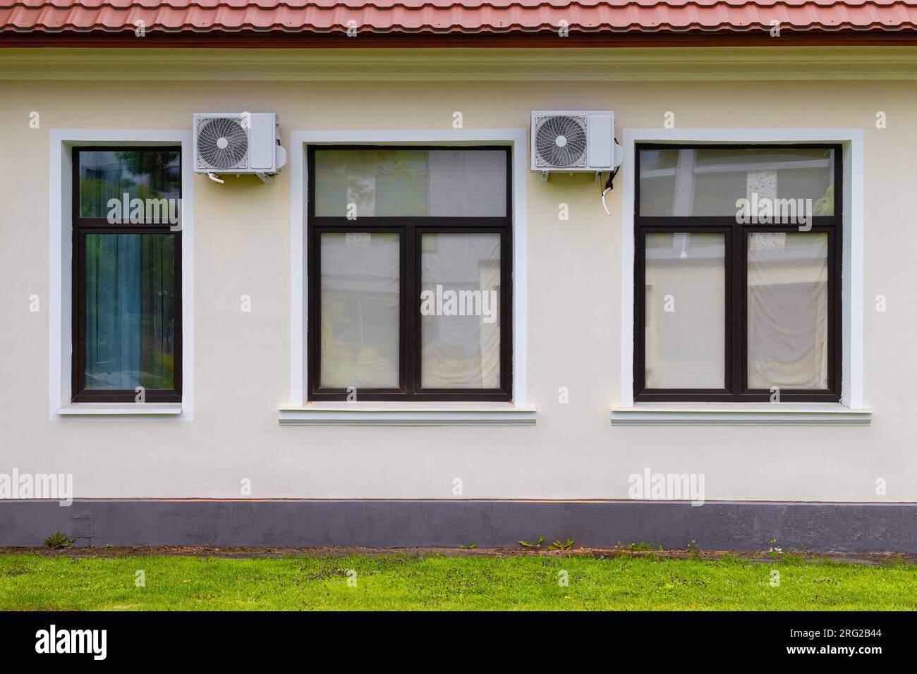outdoor air conditioning unit installed on the facade of the house ...