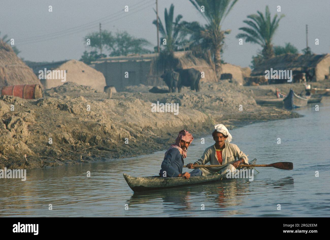 Marsh Arabs Iraq. Marsh Arab men in boat, adobe homes, houses and ...
