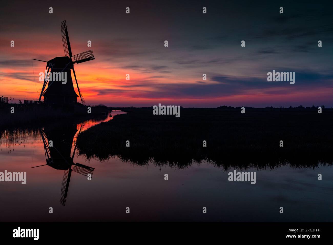 Dutch windmill in the early morning light Stock Photo - Alamy