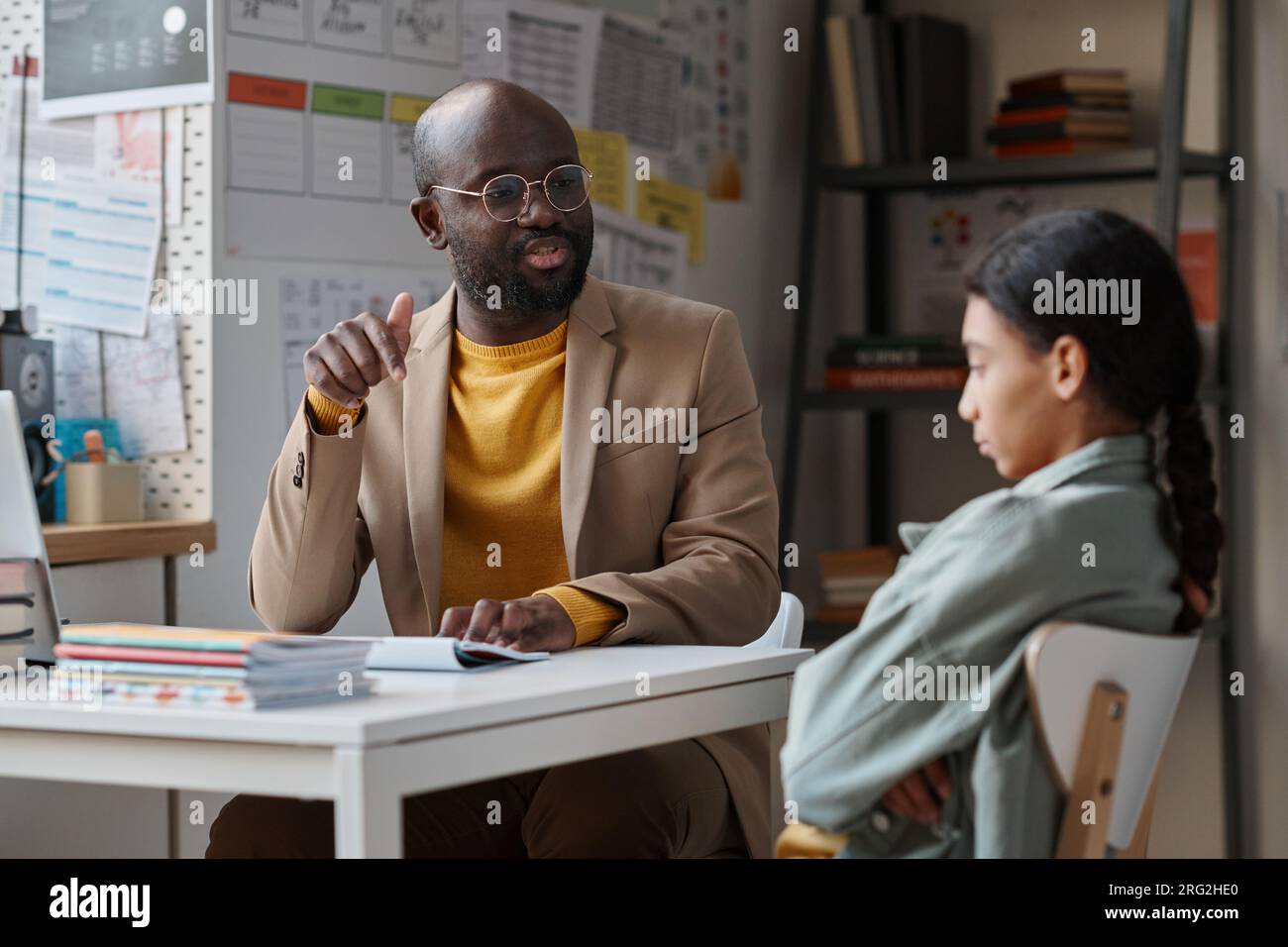 African American teacher having a serious conversation with difficult ...
