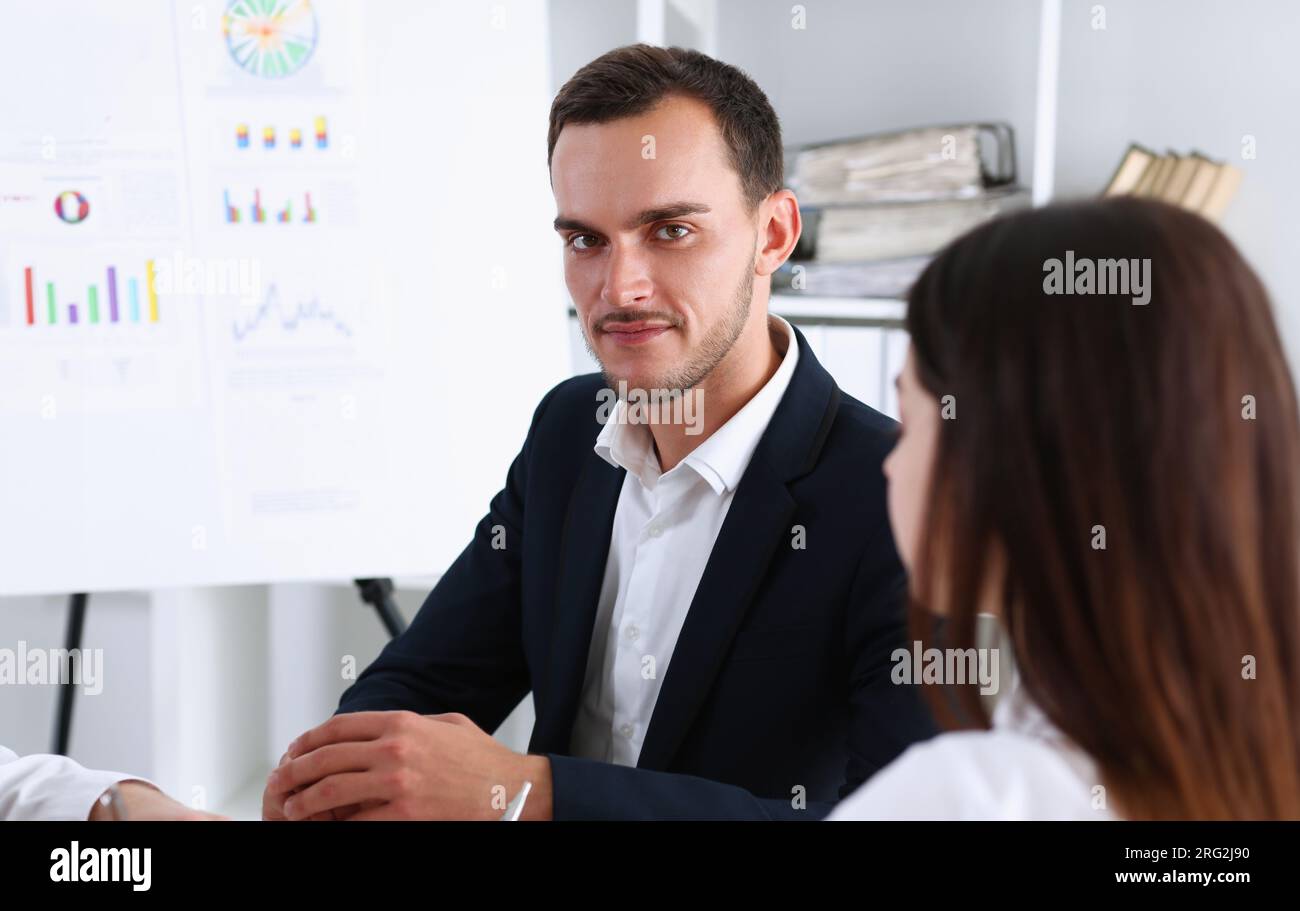 Group of people deliberate on white board Stock Photo - Alamy