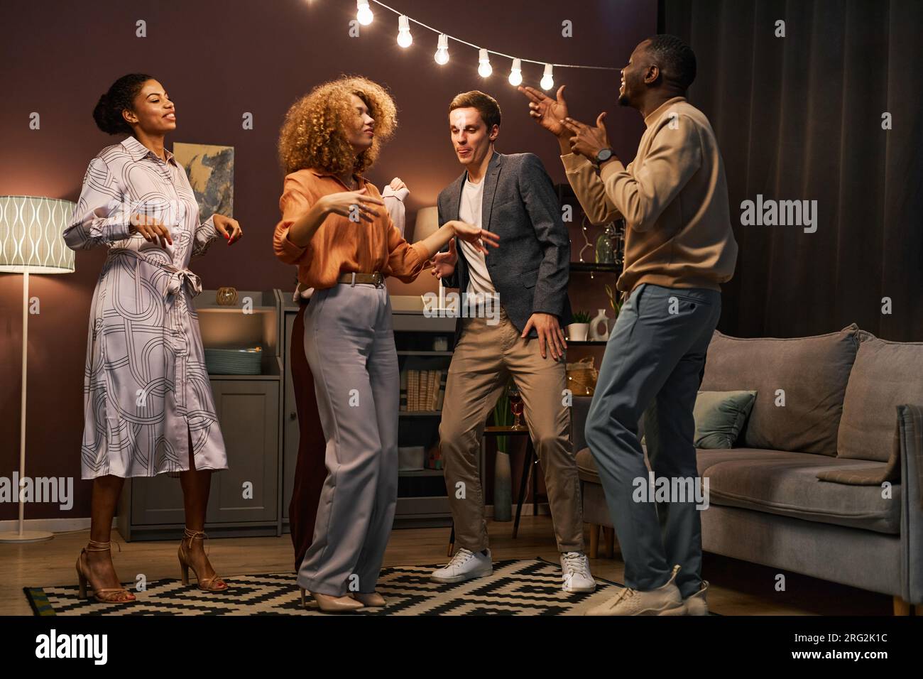 Group of happy young friends in casualewar dancing together while ...