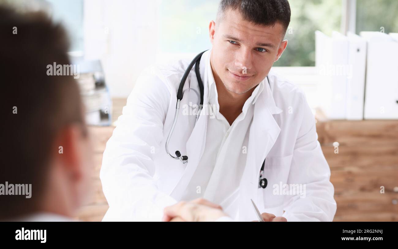 Doctor shake hand as hello with patient Stock Photo - Alamy