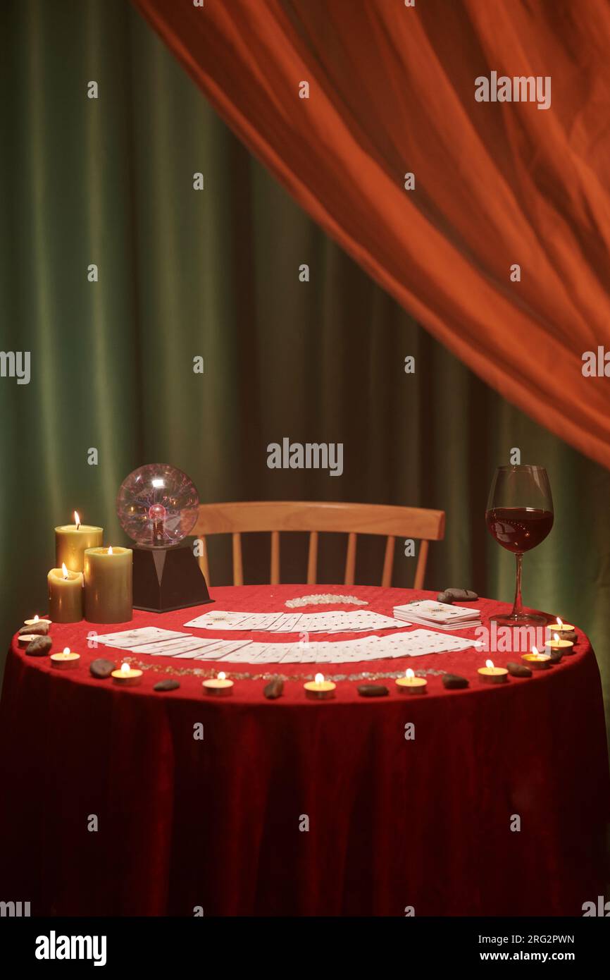 Crystal ball, burning candles and tarot cards on table of Stock Photo ...