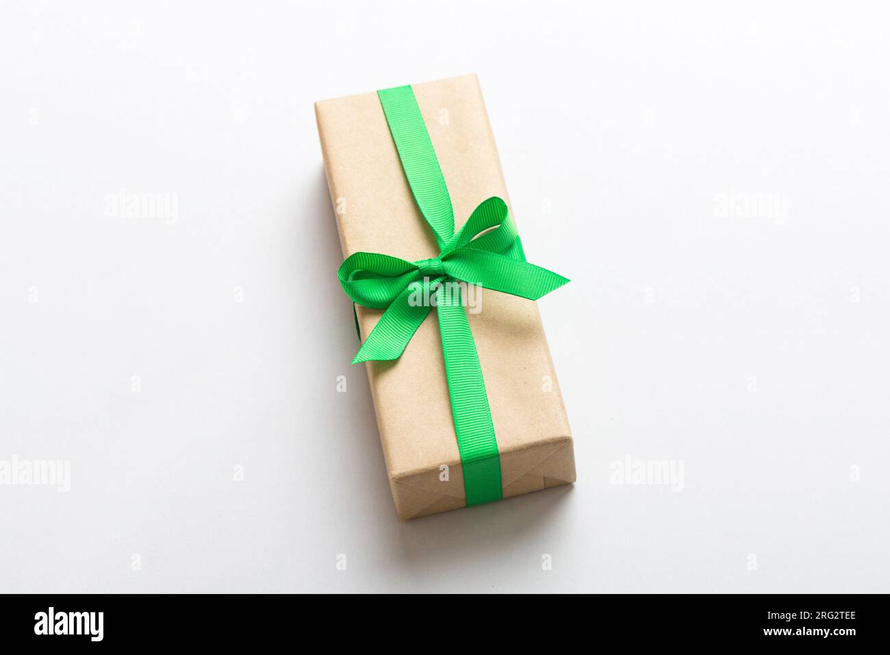 Wrapped christmas or other holiday handmade present in craft paper with ...