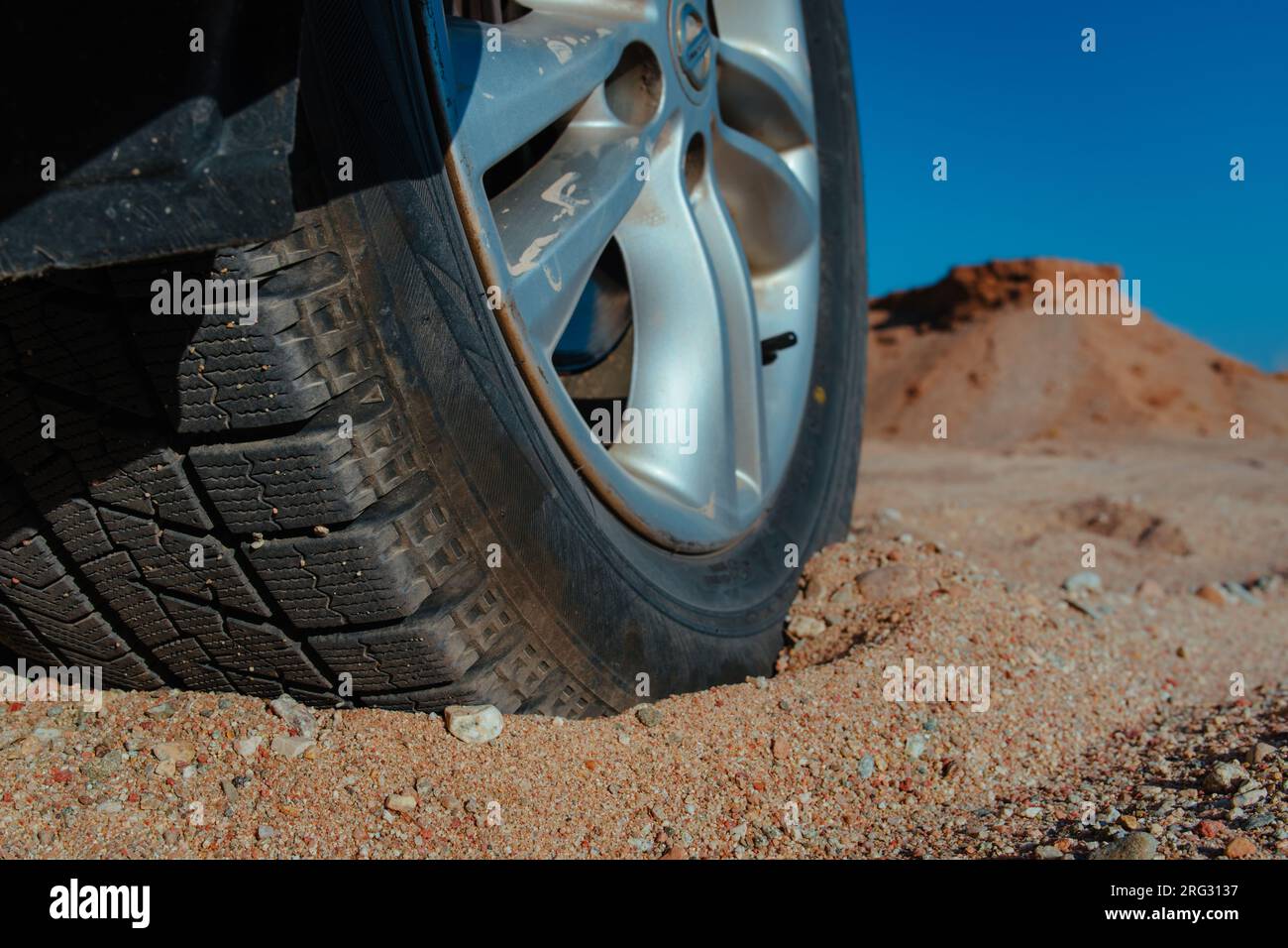 Car wheel on sand close-up view Stock Photo - Alamy