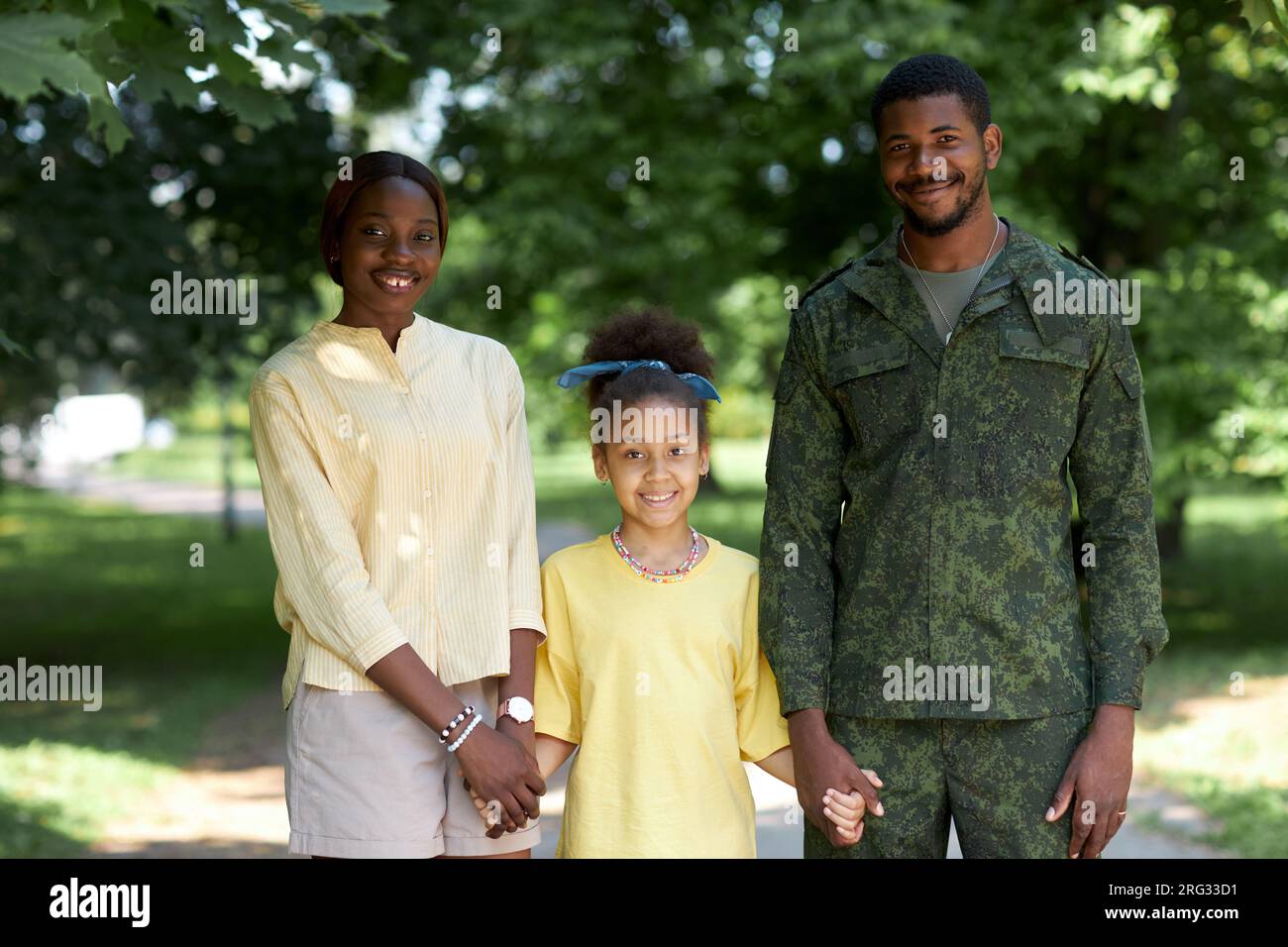 Portrait of African American family of three with their military dad ...