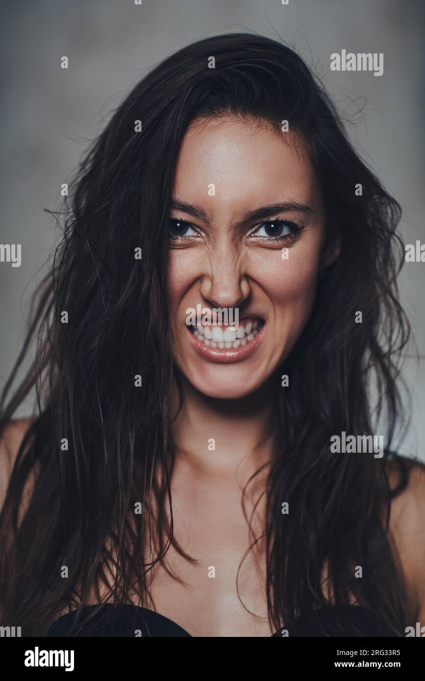 Portrait of an angry brunette woman Stock Photo - Alamy