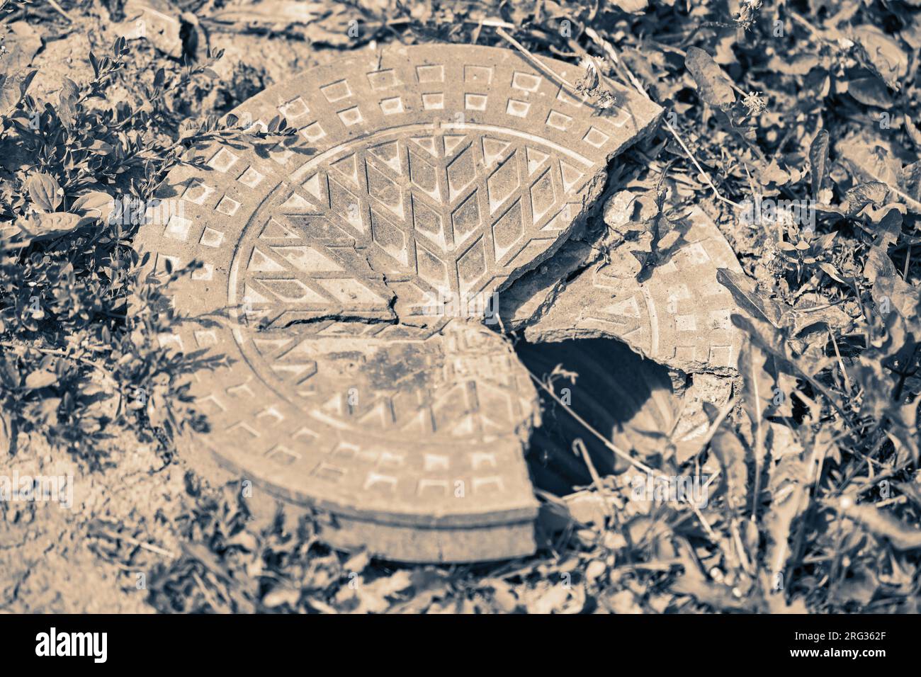 A broken metal manhole cover, an open well in the grass Stock Photo - Alamy