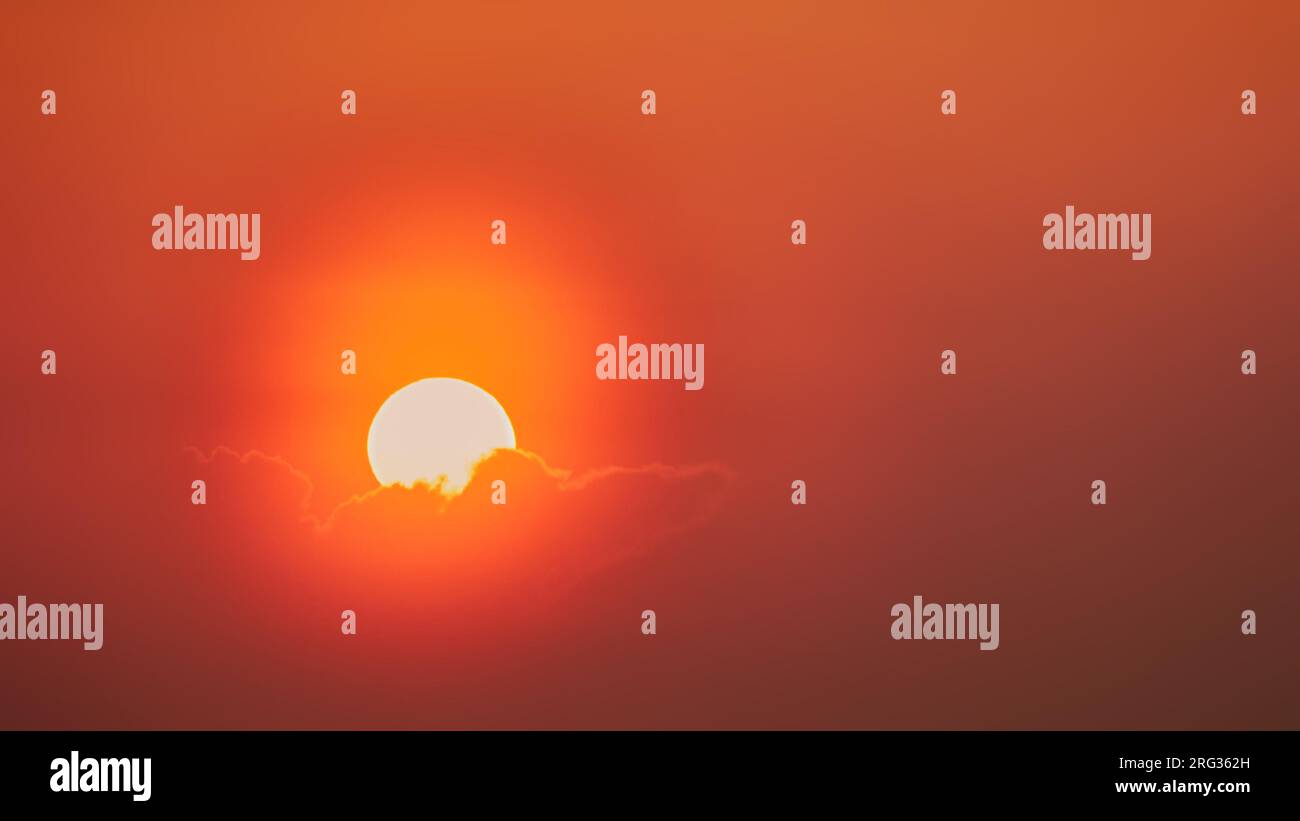 The large orange sun slowly disappeared behind the horizon, leaving ...