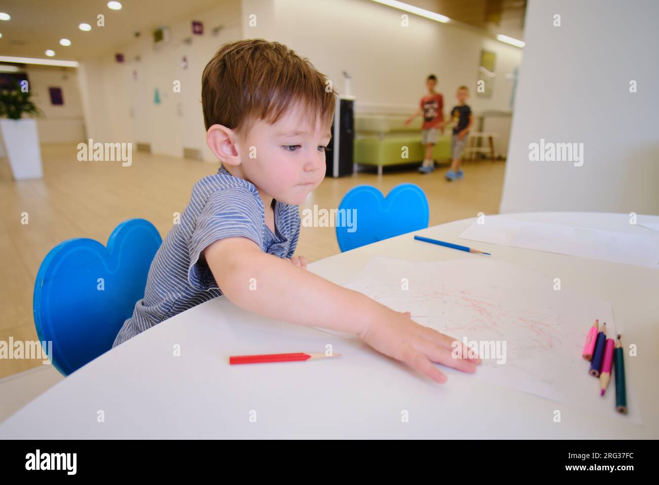 The child is learning and developing their creativity by drawing with a ...