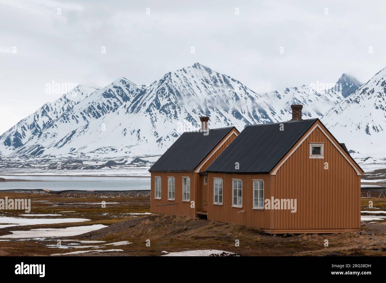 Colorful buildings near mountains and arctic waters at the research ...