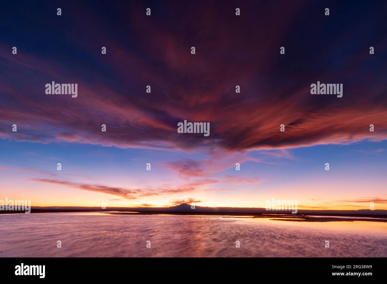 Red clouds at sunset over Chaxa lagoon in the Salar de Atacama. Chaxa ...