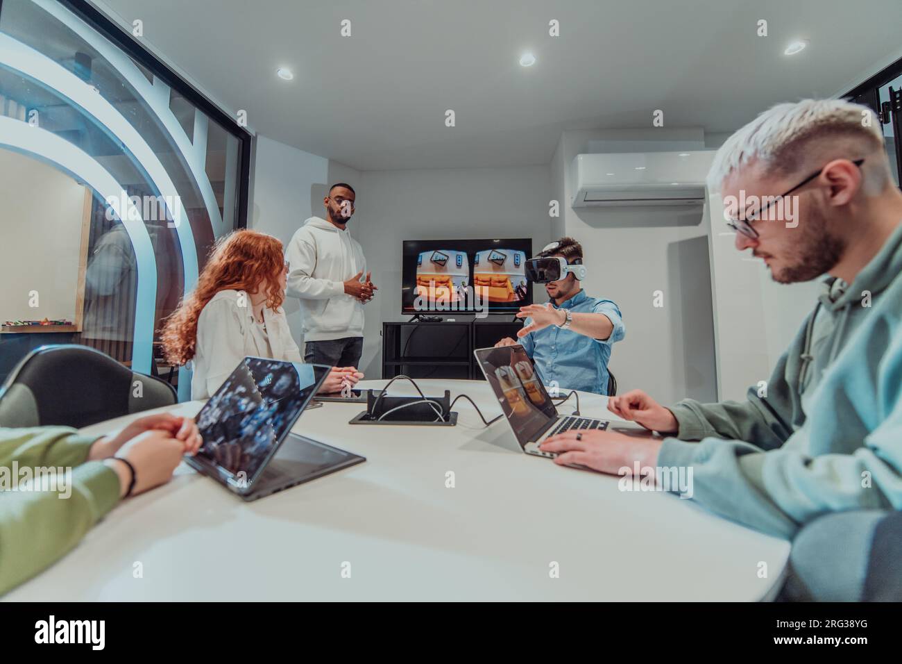 A diverse group of businessmen collaborates and tests a new virtual ...