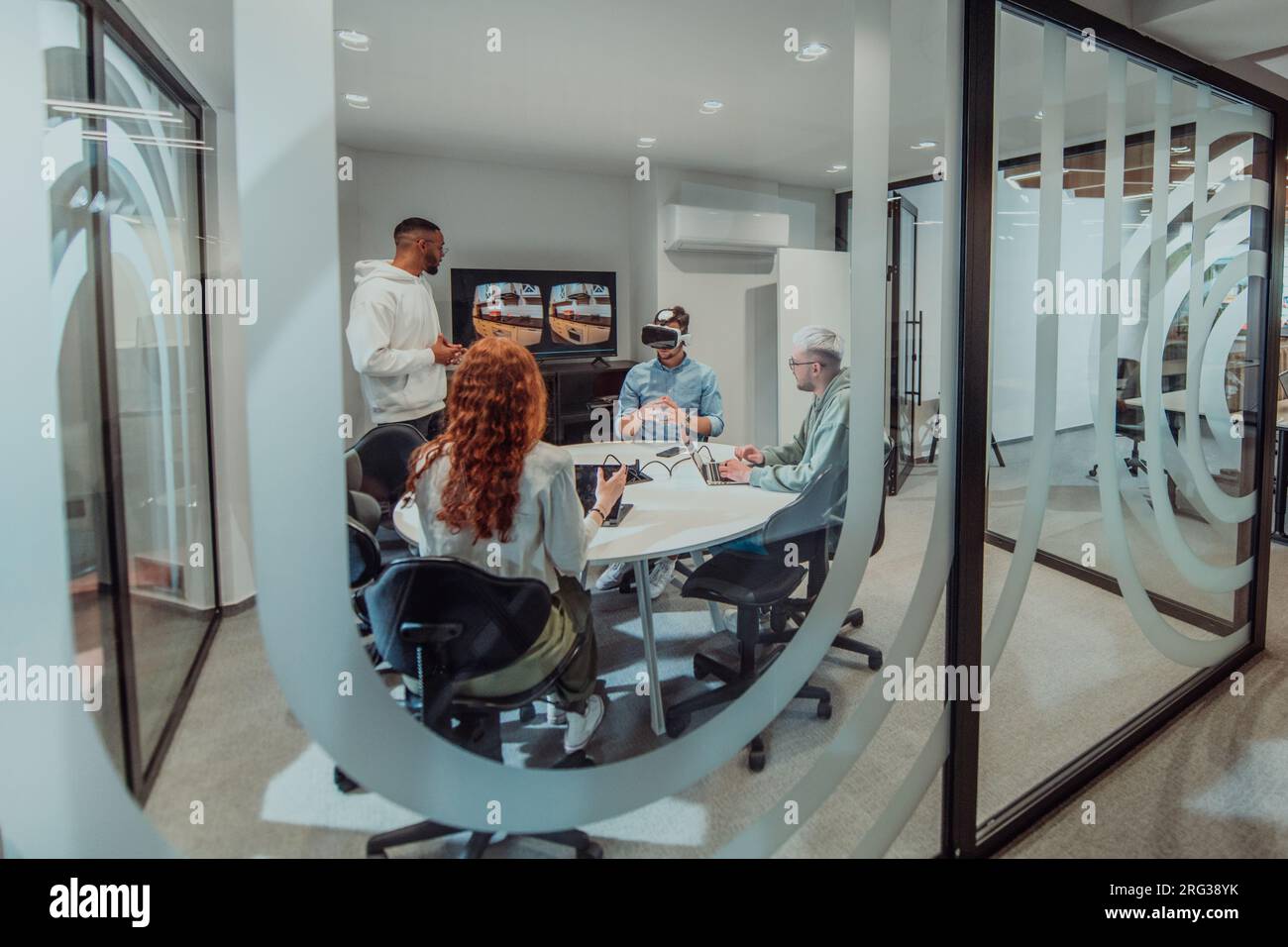 A diverse group of businessmen collaborates and tests a new virtual ...