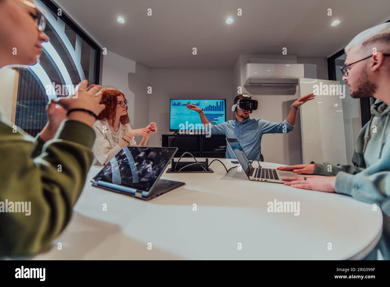 A diverse group of businessmen collaborates and tests a new virtual ...