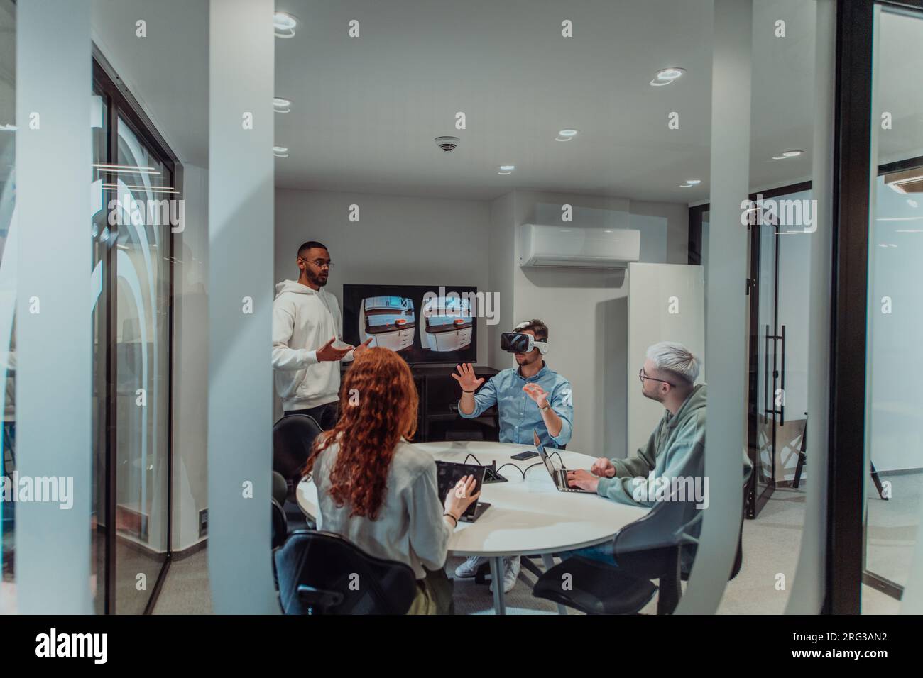 A diverse group of businessmen collaborates and tests a new virtual ...