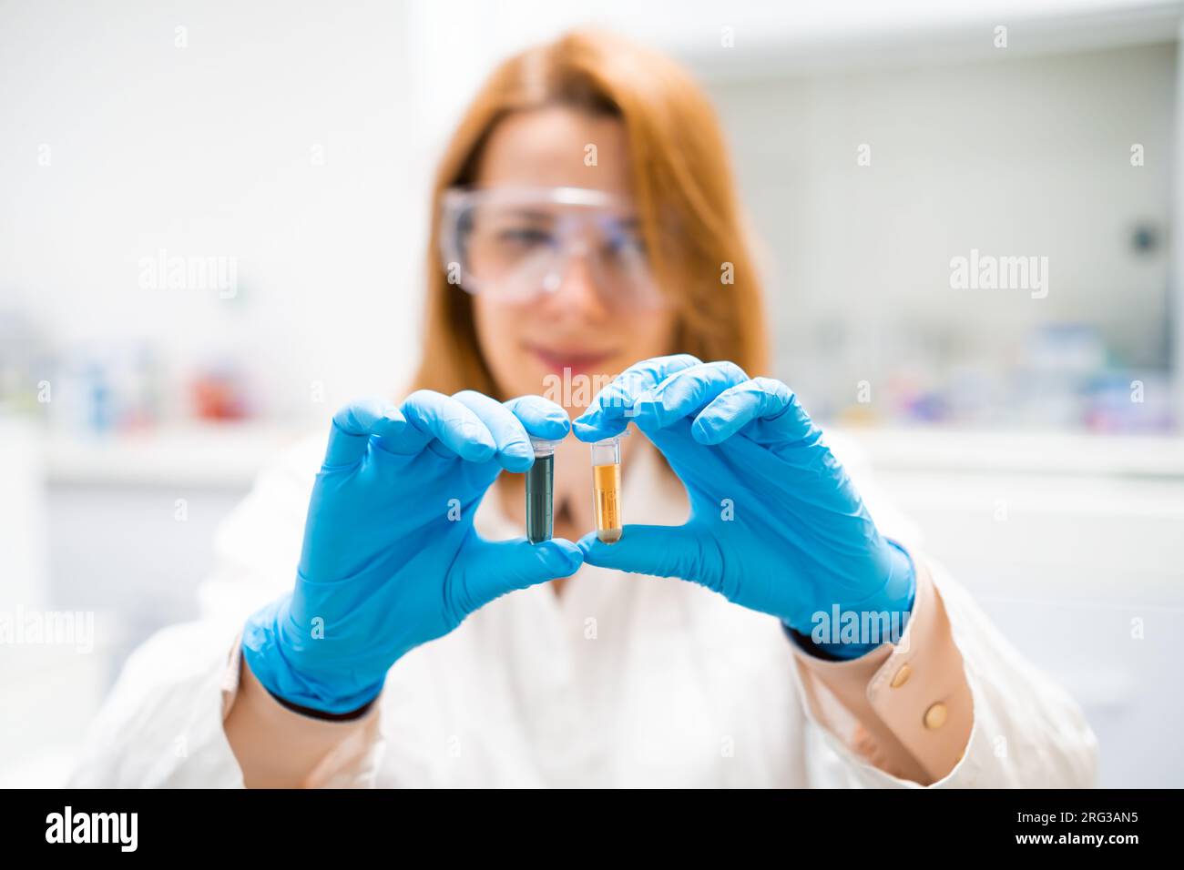 Female research scientist shaking yellow hi-res stock photography and ...