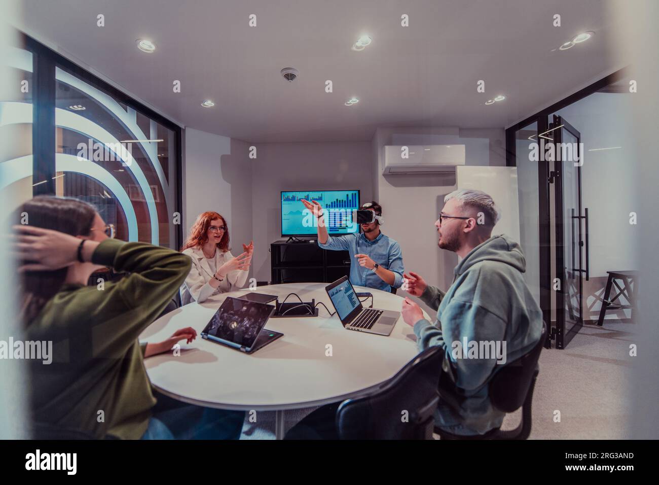 A diverse group of businessmen collaborates and tests a new virtual ...