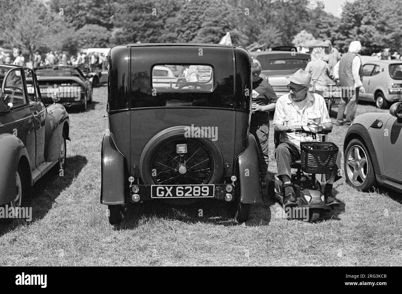 Old man and small child look at a Austin 7 pre war classic car Shot on ...