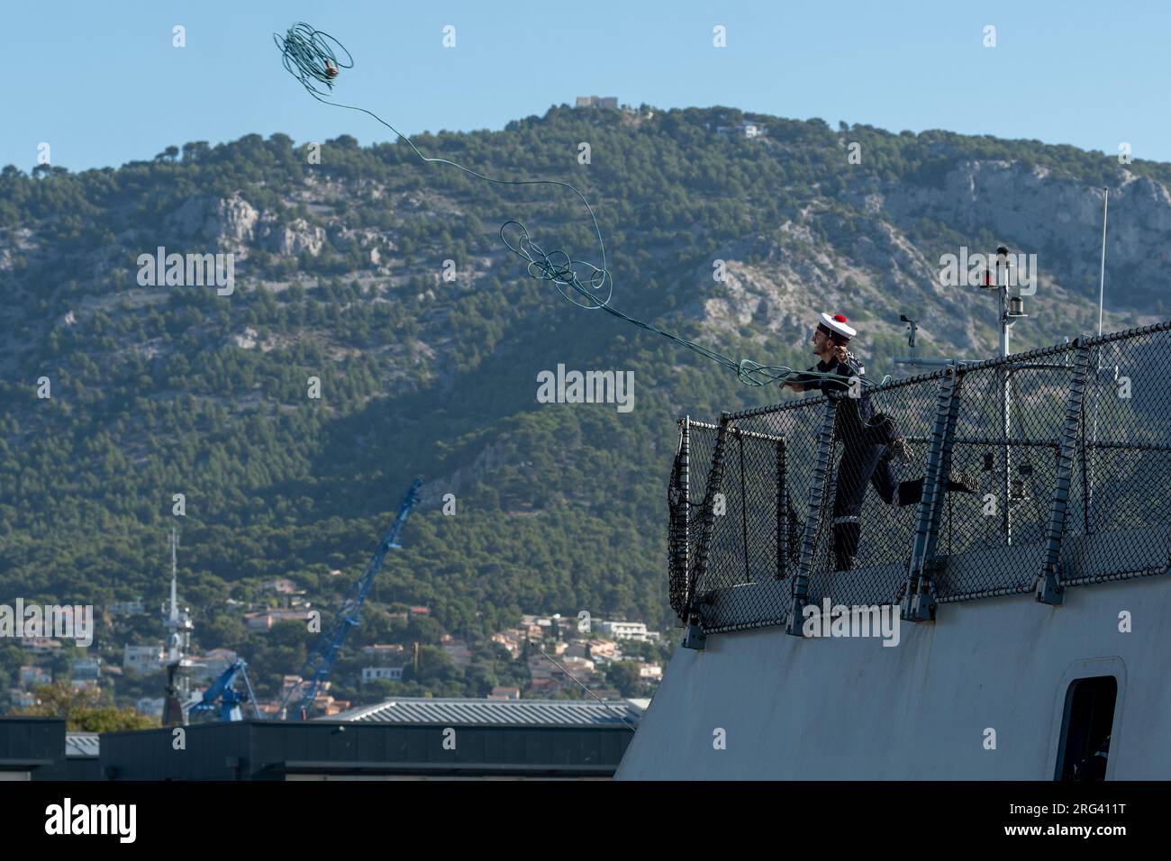Crew members preparing the moorings at the arrival of the multi-mission ...