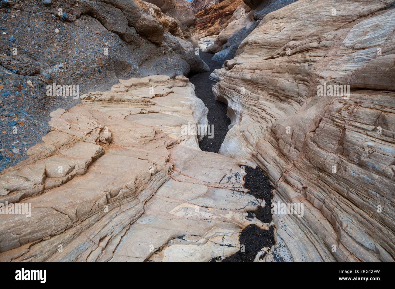 An asphalt trail leads through the smooth white polished marble walls ...