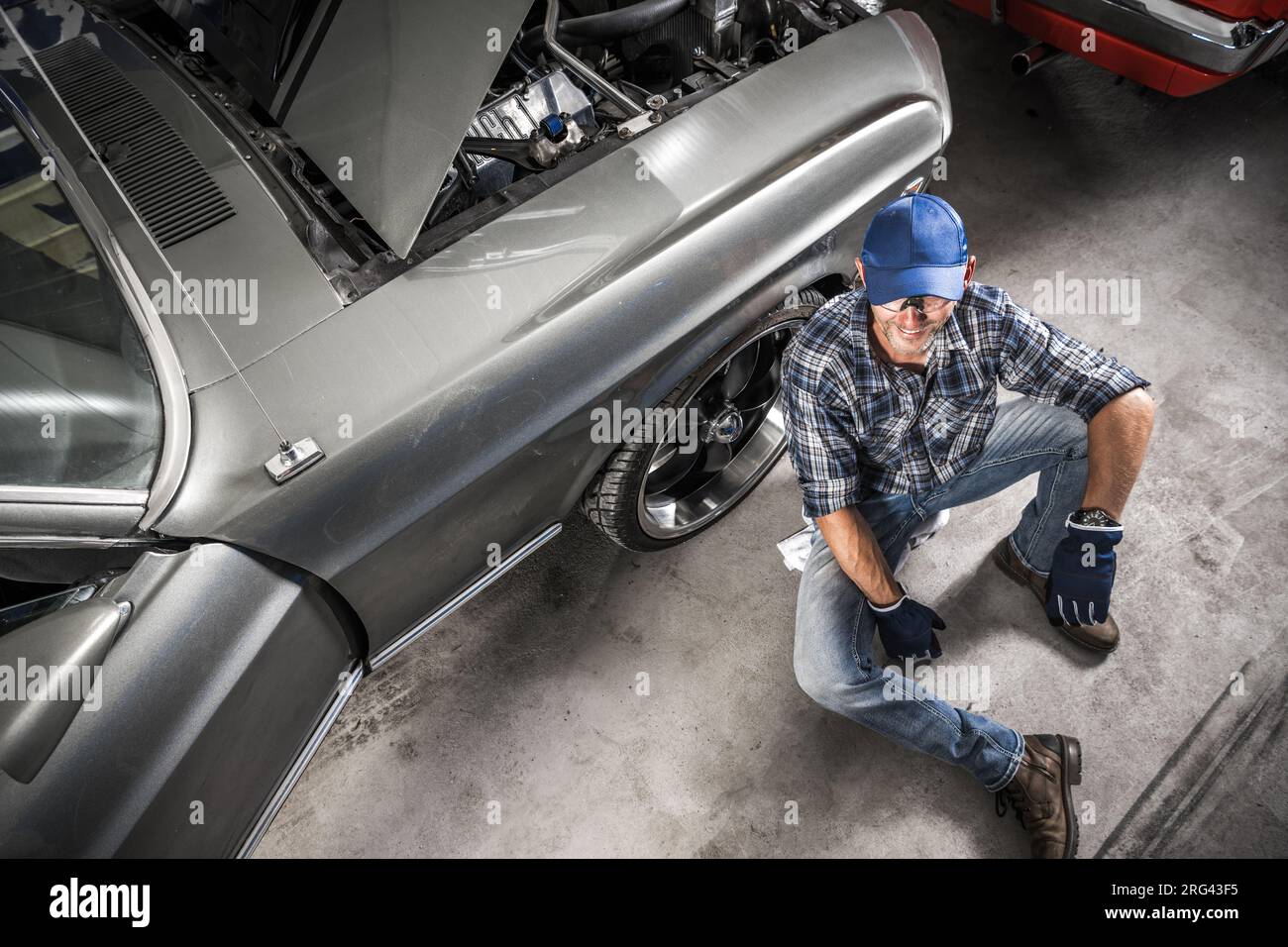 Smiling Caucasian Car Mechanic and His Workshop. Seating Next to ...