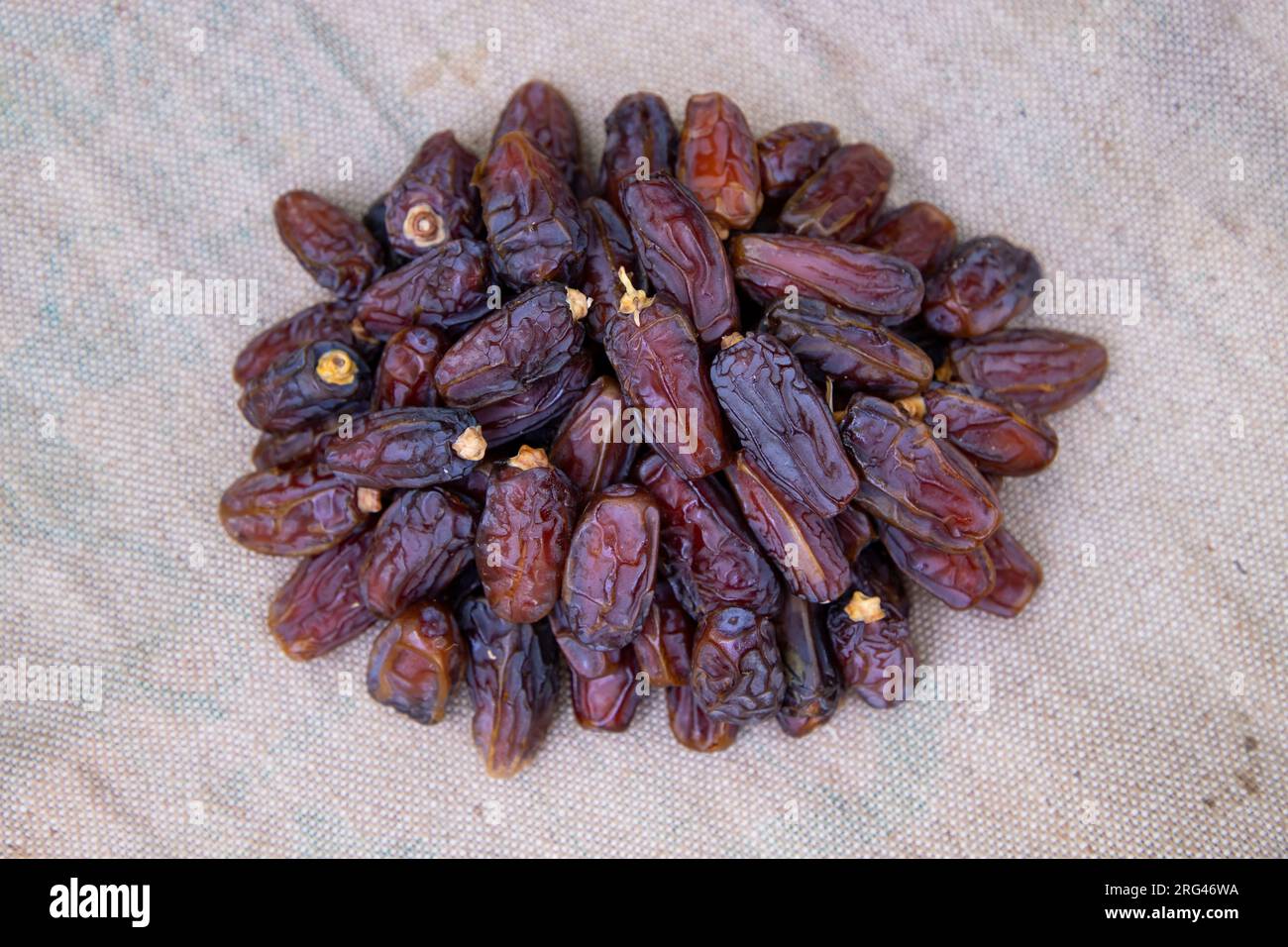 Some delicious Date fruits on the brown jute fiber fabric to eat during ...