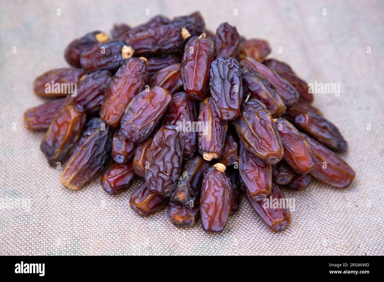 Some delicious Date fruits on the brown jute fiber fabric to eat during ...