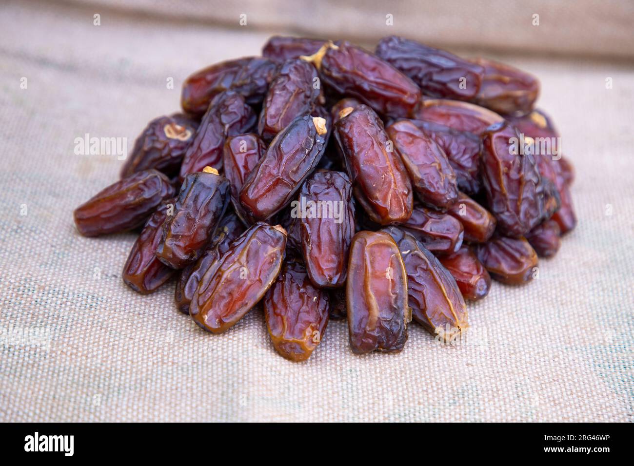 Some delicious Date fruits on the brown jute fiber fabric to eat during ...