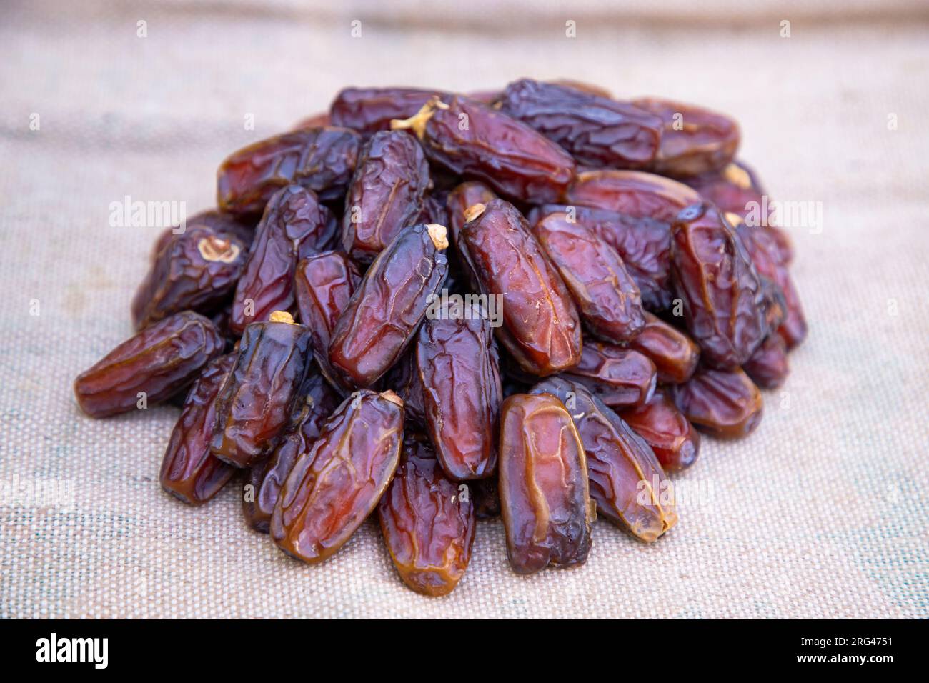 Some delicious Date fruits on the brown jute fiber fabric to eat during ...