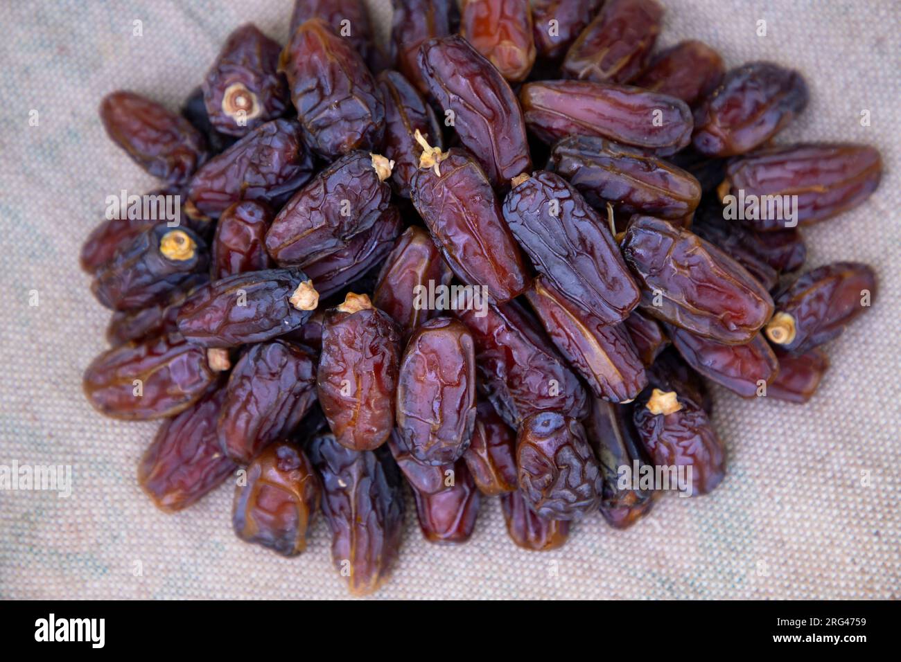 Some delicious Date fruits on the brown jute fiber fabric to eat during ...