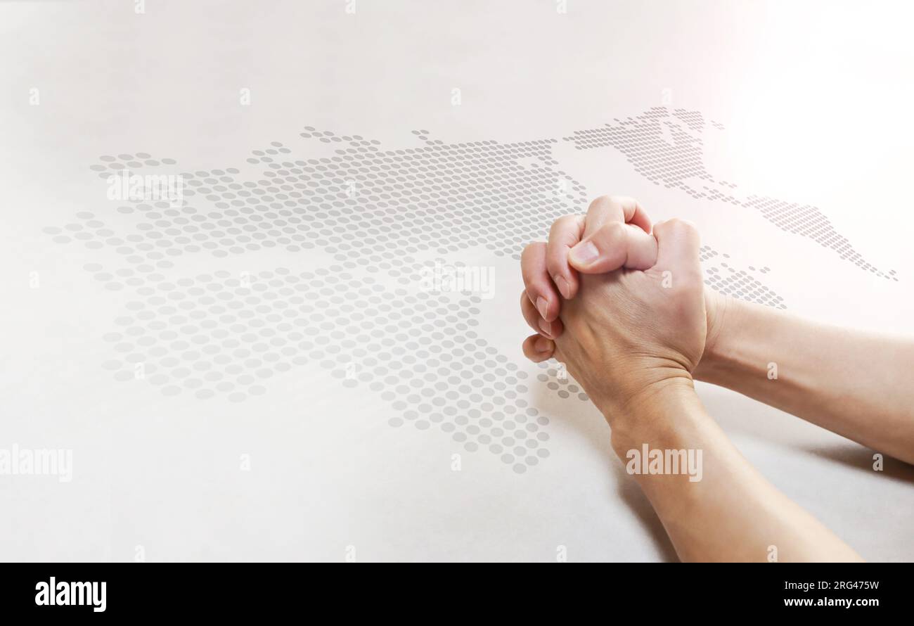 Christian praying with hands together for global mission and world ...