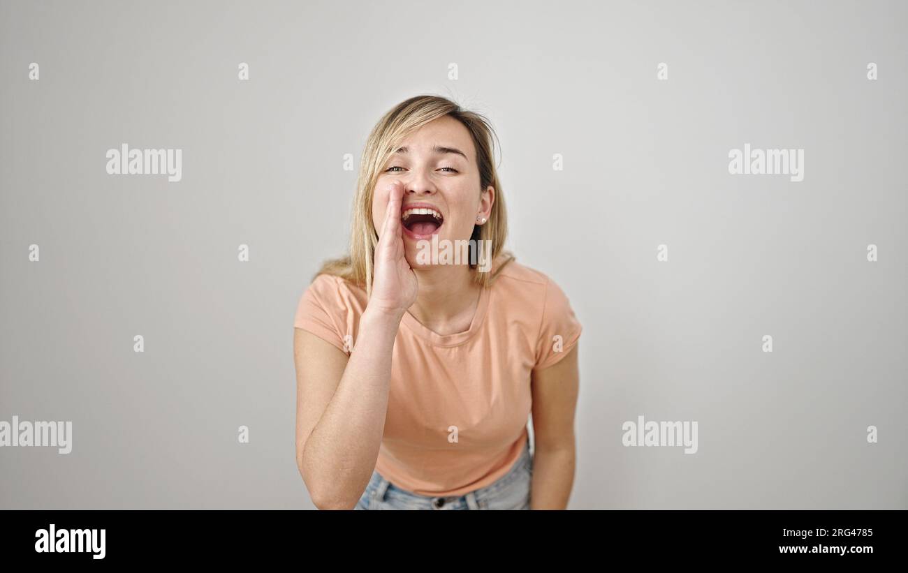 Young blonde woman screaming over isolated white background Stock Photo ...