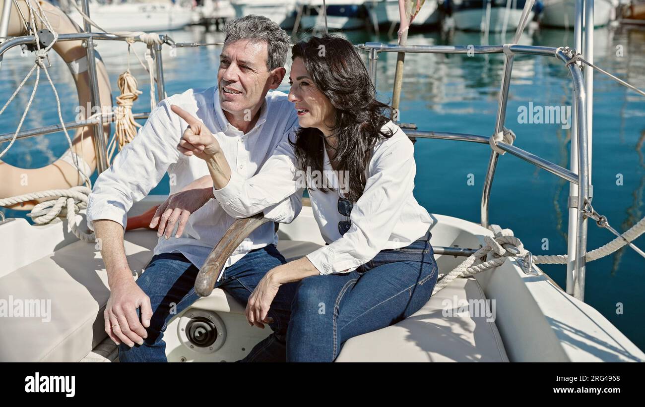 Senior man and woman couple sitting together on boat speaking at boat ...
