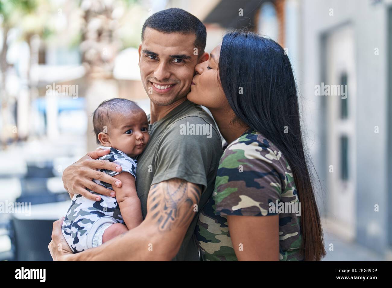 Hispanic family hugging each other kissing at street Stock Photo - Alamy