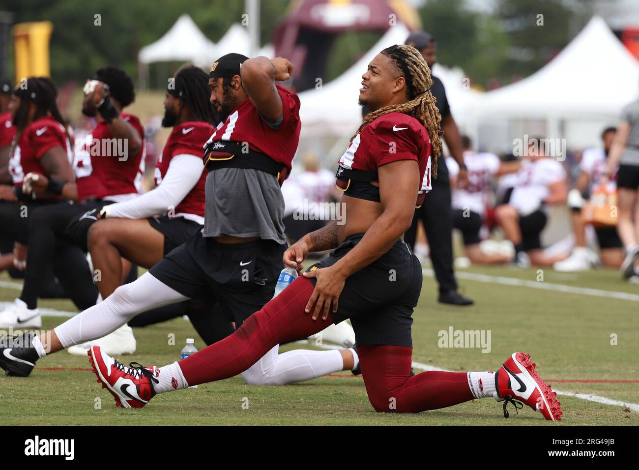 Washington Commanders DE Chase Young (99) warming up with stretches ...