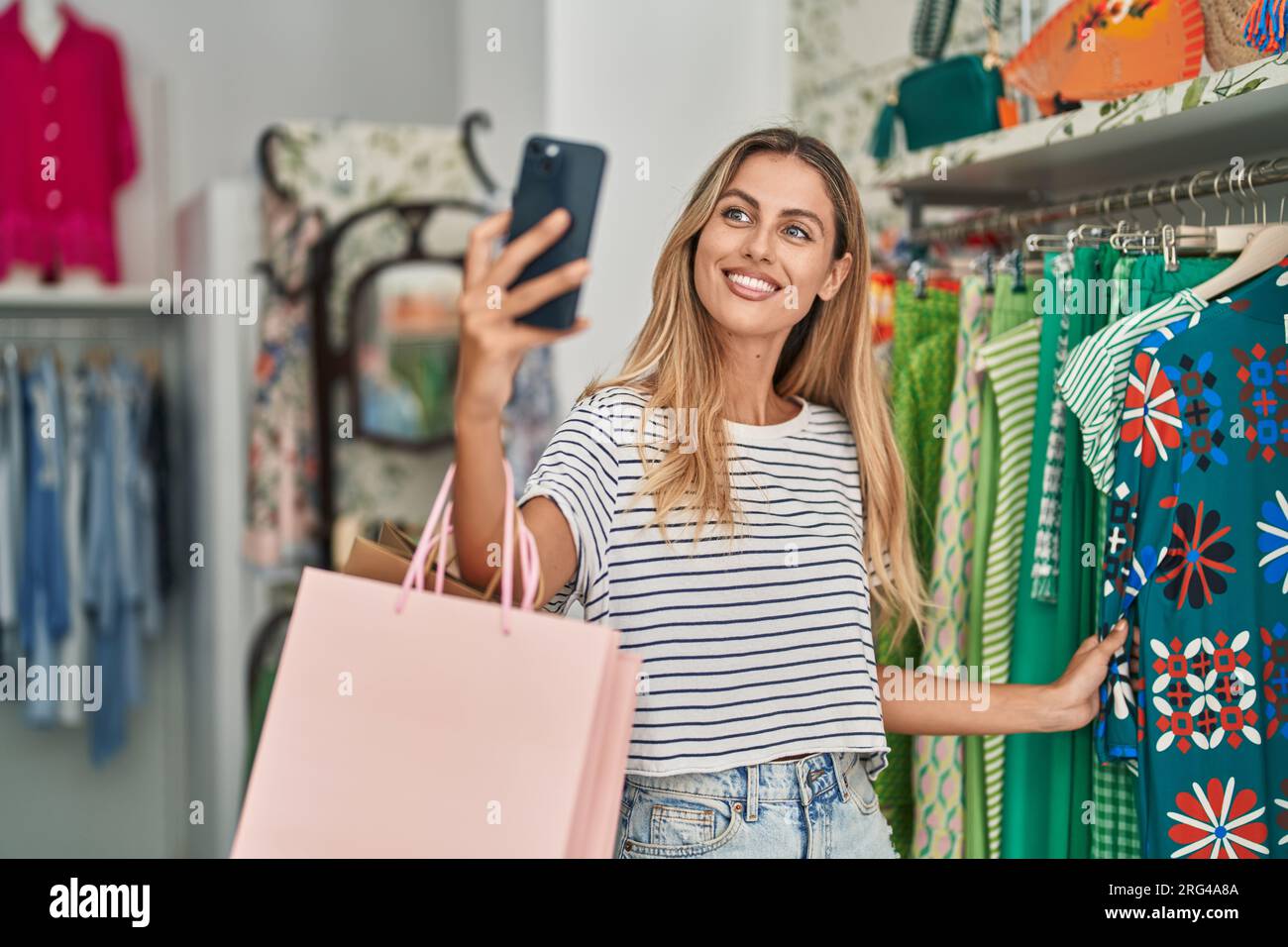 Young blonde woman customer smiling confident make selfie by smartphone ...