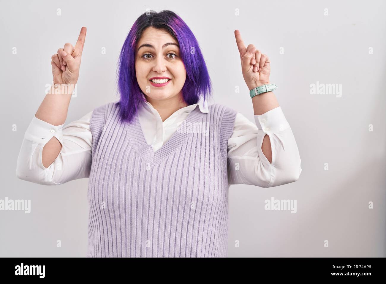 Plus size woman wit purple hair standing over white background smiling ...