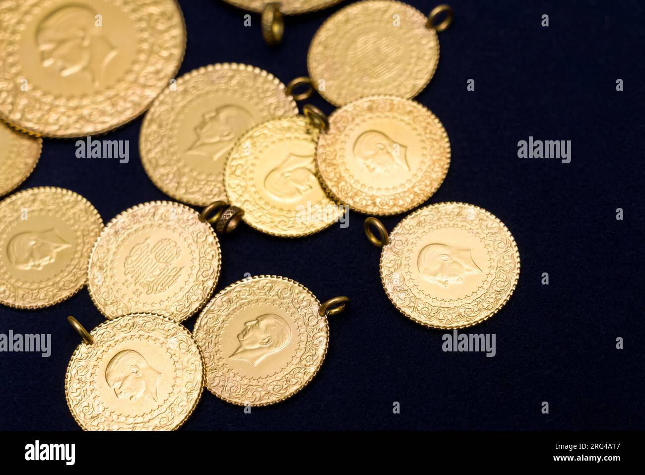 The pile of full, half and quarter Turkish gold coins on a dark navy ...