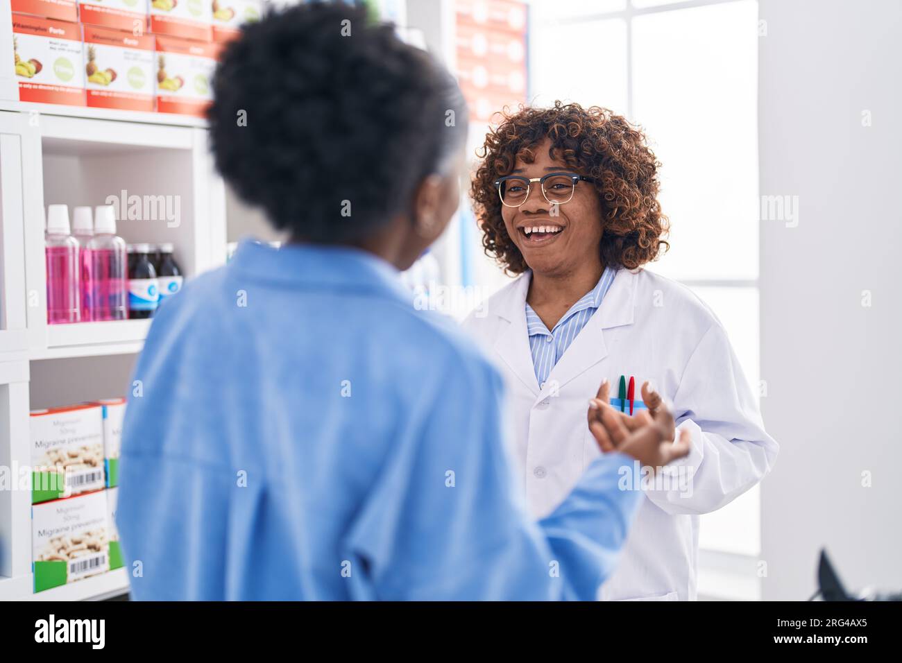 African american women pharmacist and customer speaking at pharmacy ...