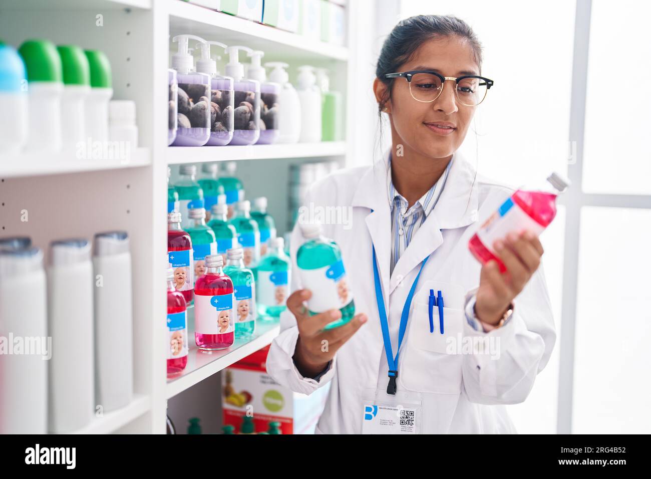 Young beautiful hispanic woman pharmacist smiling confident holding ...