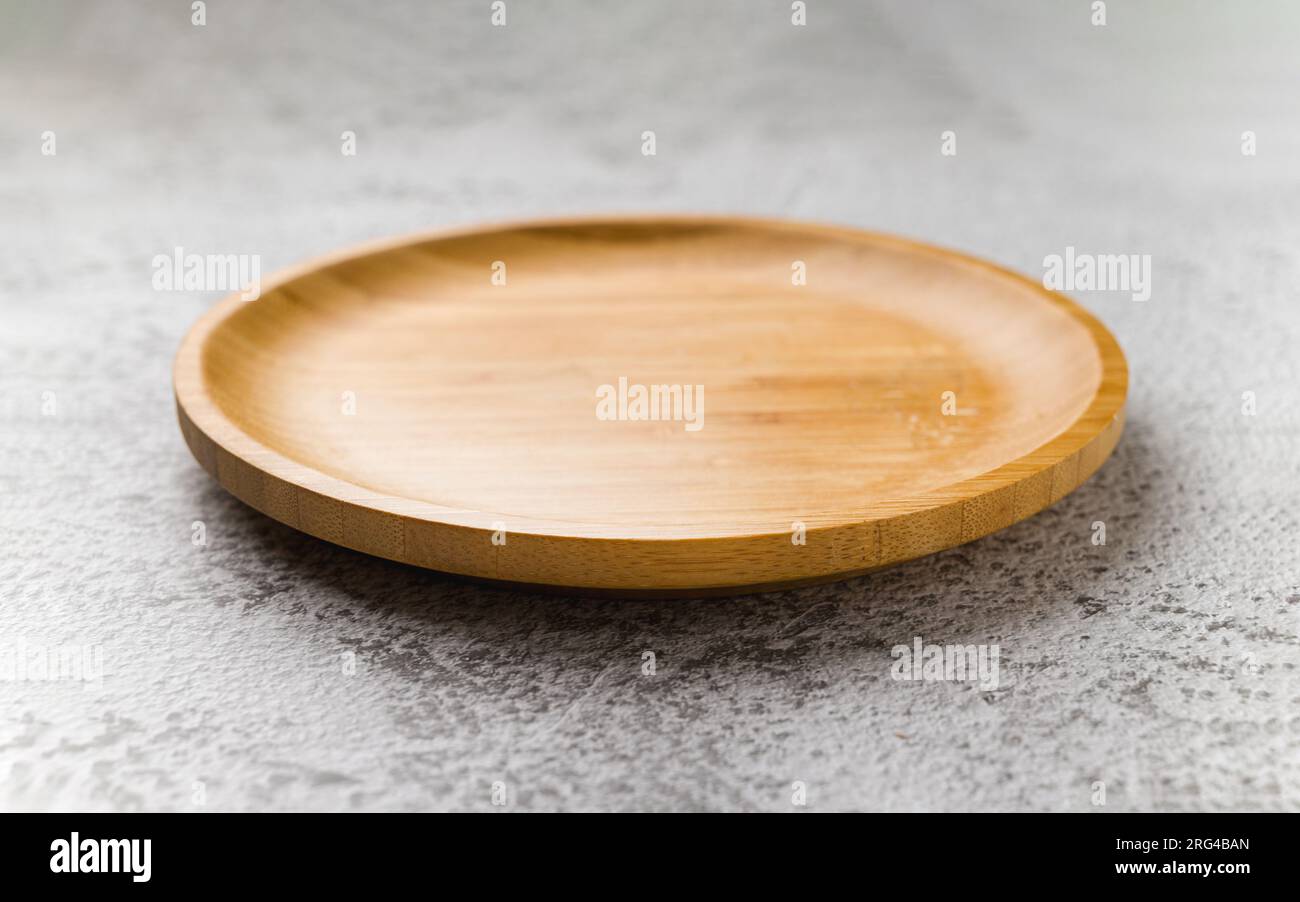Wooden plate on a white stone background. handmade cooking utensils ...