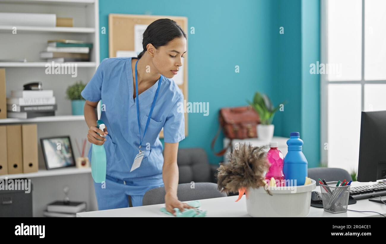 African american woman professional cleaner cleaning table at the ...