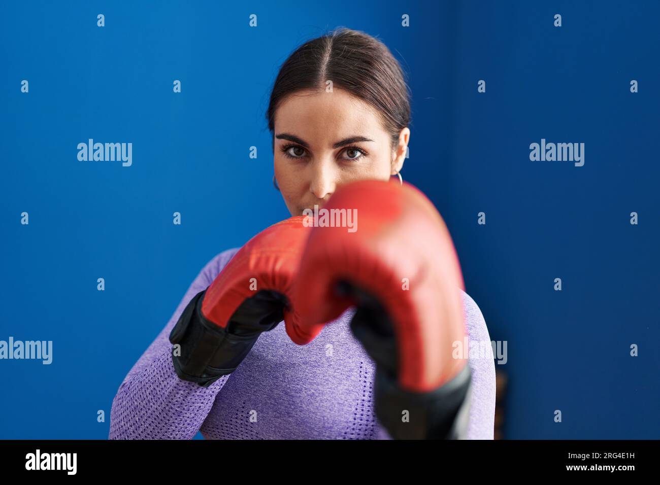 Young beautiful hispanic woman boxing at sport center Stock Photo - Alamy