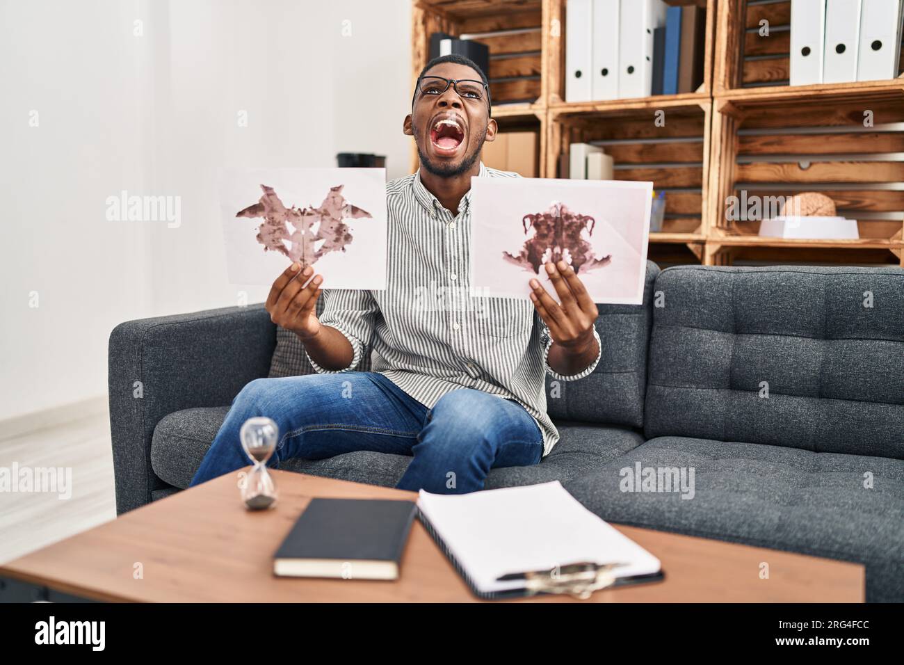 African american man working with rorschach test at psychology clinic ...