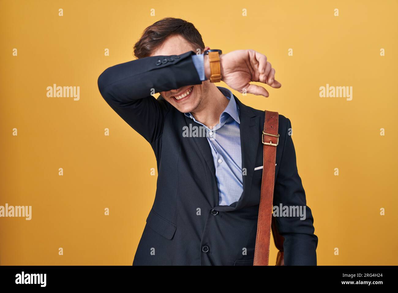 Caucasian business man over yellow background smiling cheerful playing ...