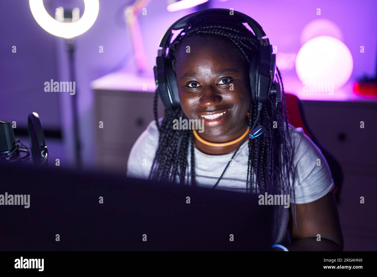 African american woman streamer smiling confident sitting on table at ...