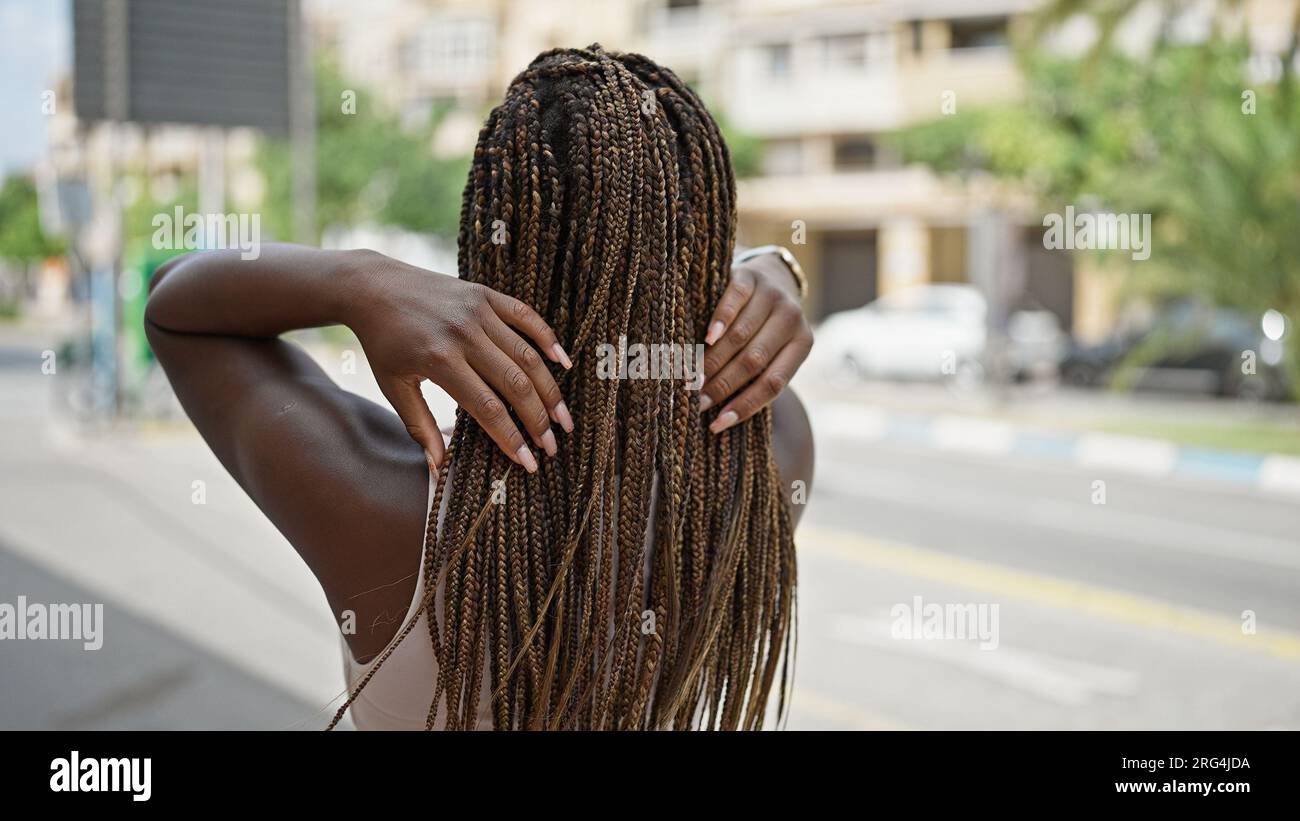 African american woman touching her hair backwards at street Stock ...