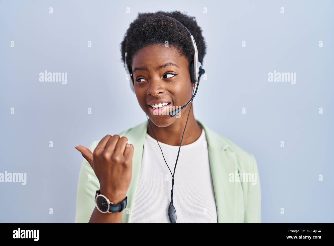 African american woman wearing call center agent headset smiling with happy face looking and ...